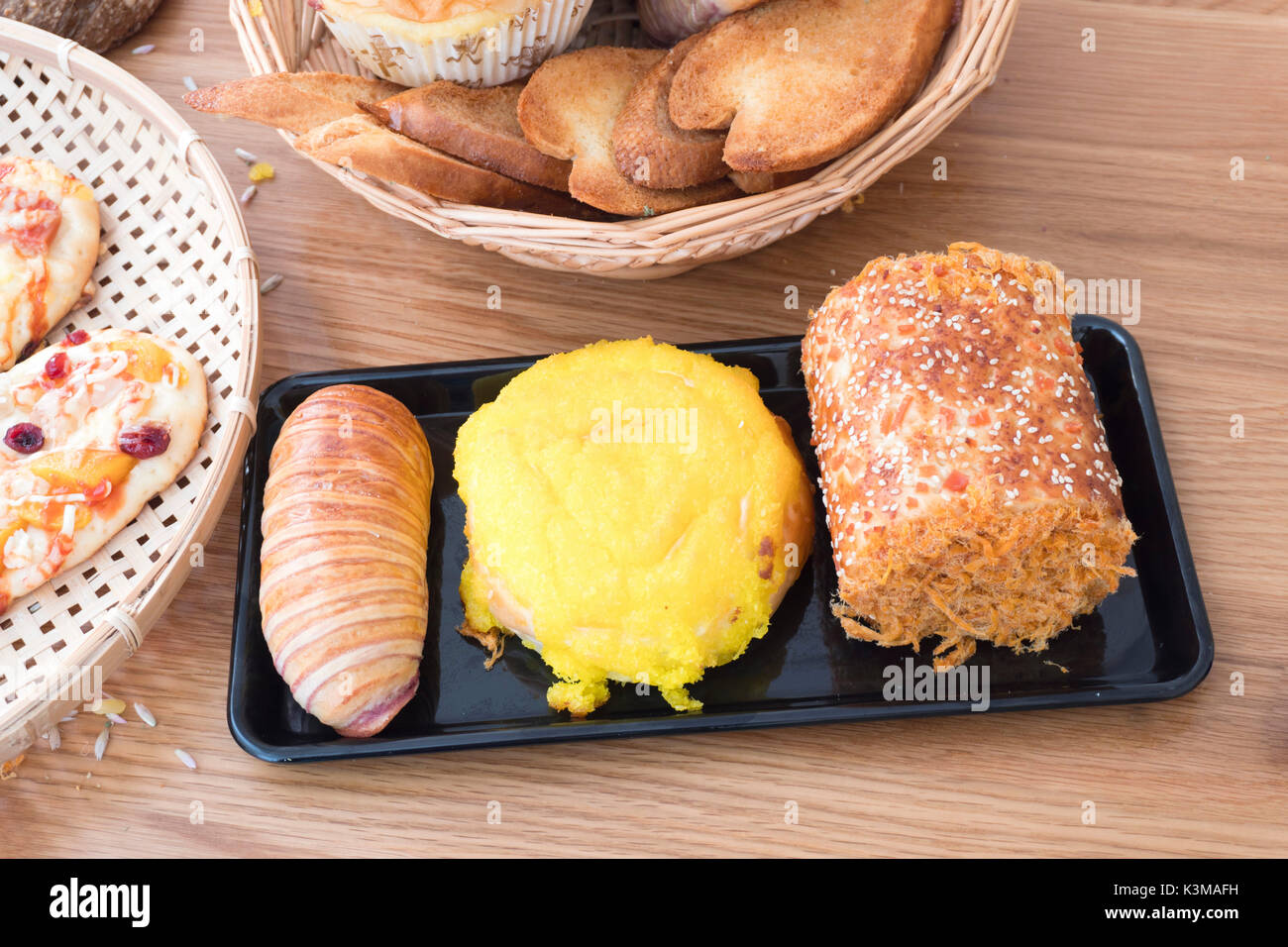 all kinds of bakery products on a wooden desk background Stock Photo ...