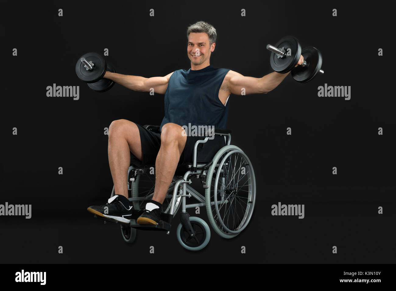 Smiling Handicapped Man On A Wheelchair Working Out With Dumbbell Stock ...