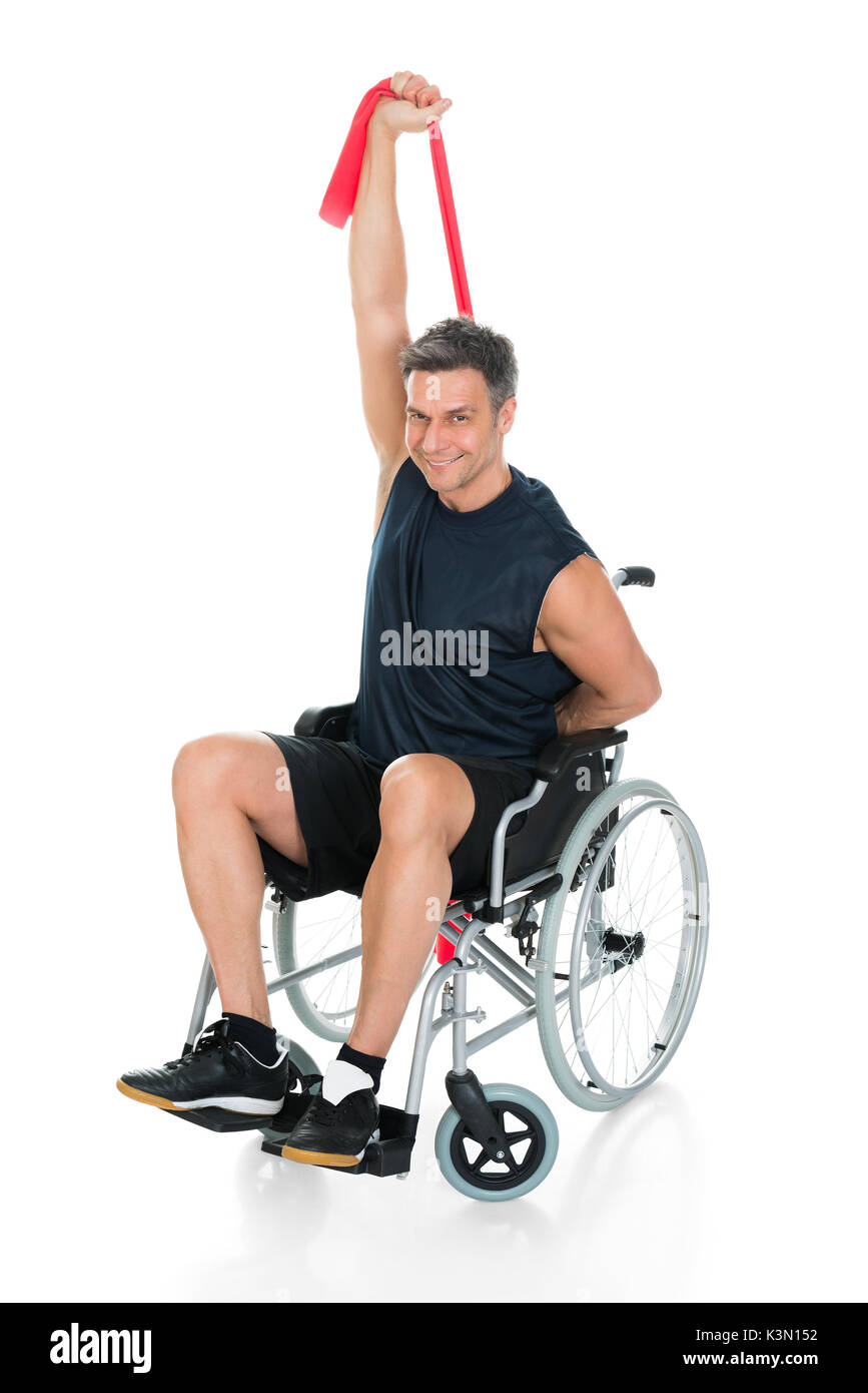 Disabled Man On Wheelchair Stretching With Resistance Band Over White ...