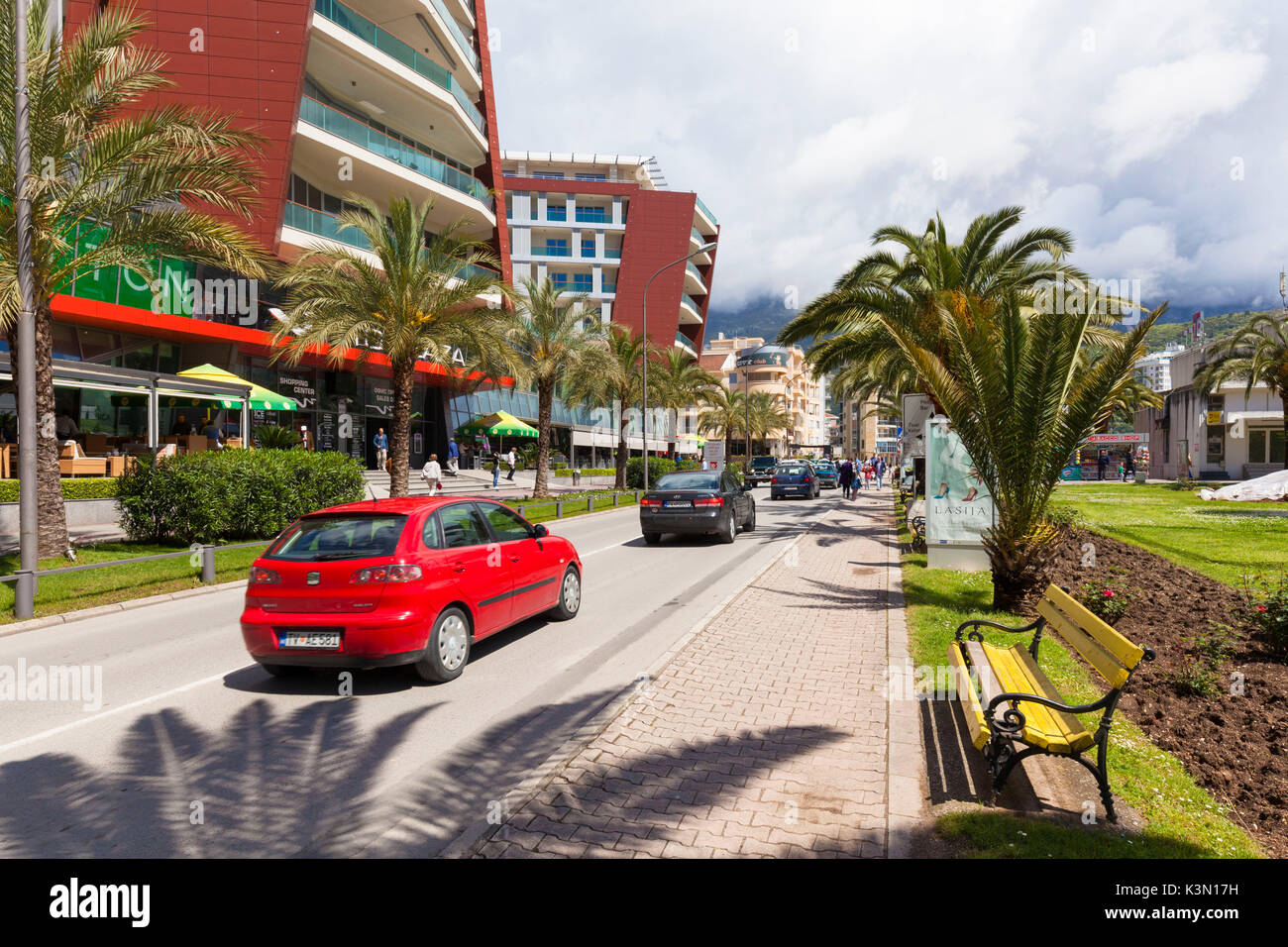 Car in transit between modern buildings and palm trees hi-res stock ...