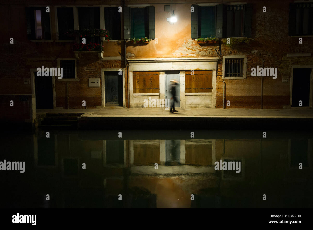 People walk in a typical Venice canal at night. Venice, Veneto, Italy ...