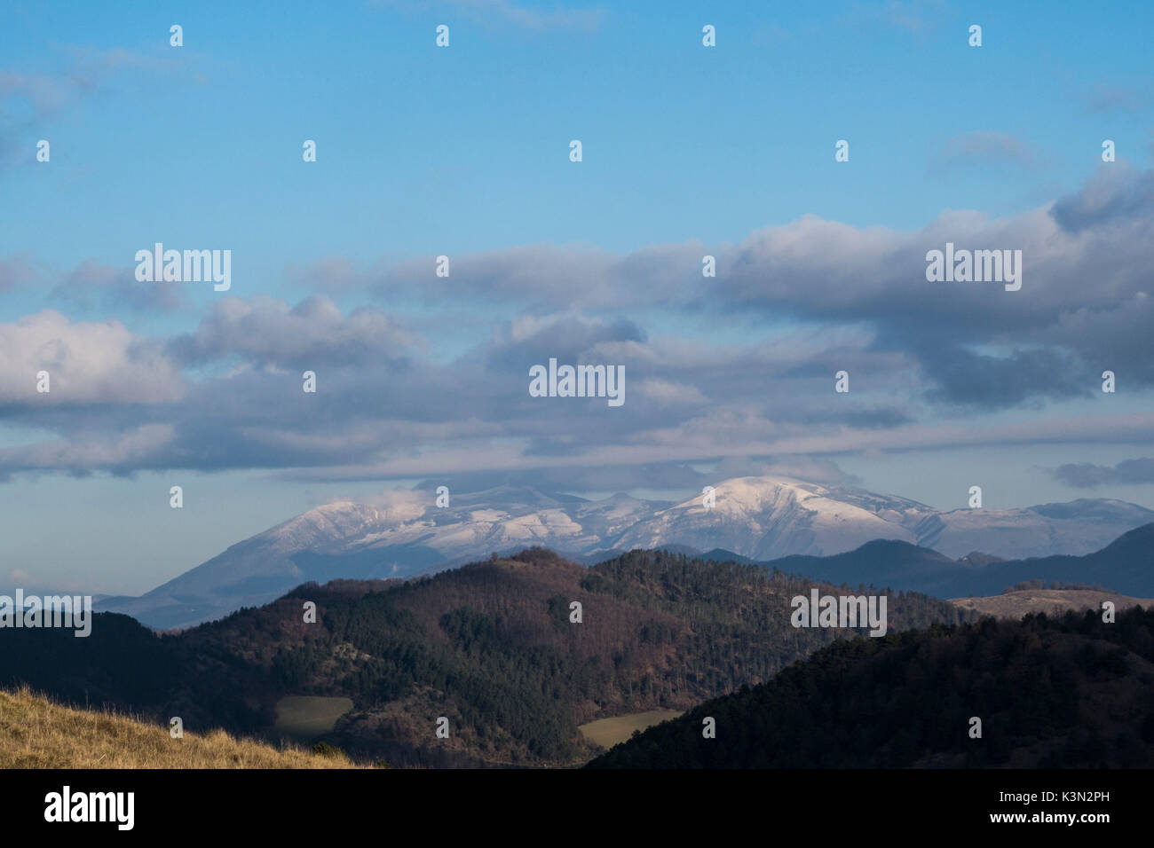 Mount Nerone with snow in winter, blue sky with clouds, Appenines ...