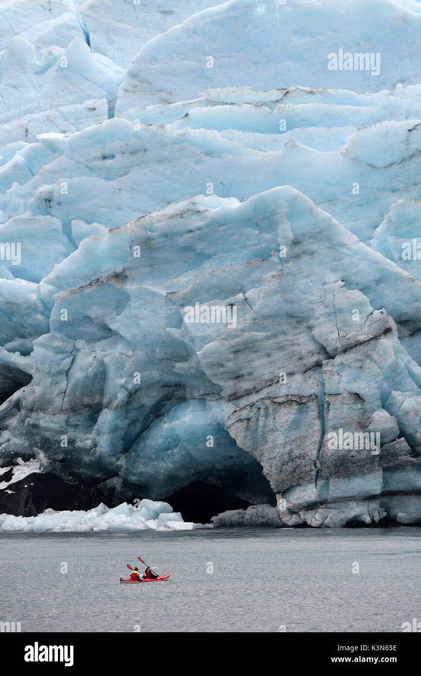 Red canoe (kayak) close to glacier front, Portage glacier, Alaska,USA ...