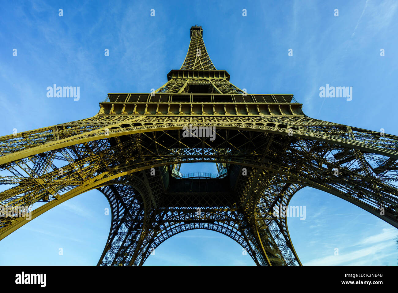 Perspective of the Eiffel Tower looking upward toward its top spire ...