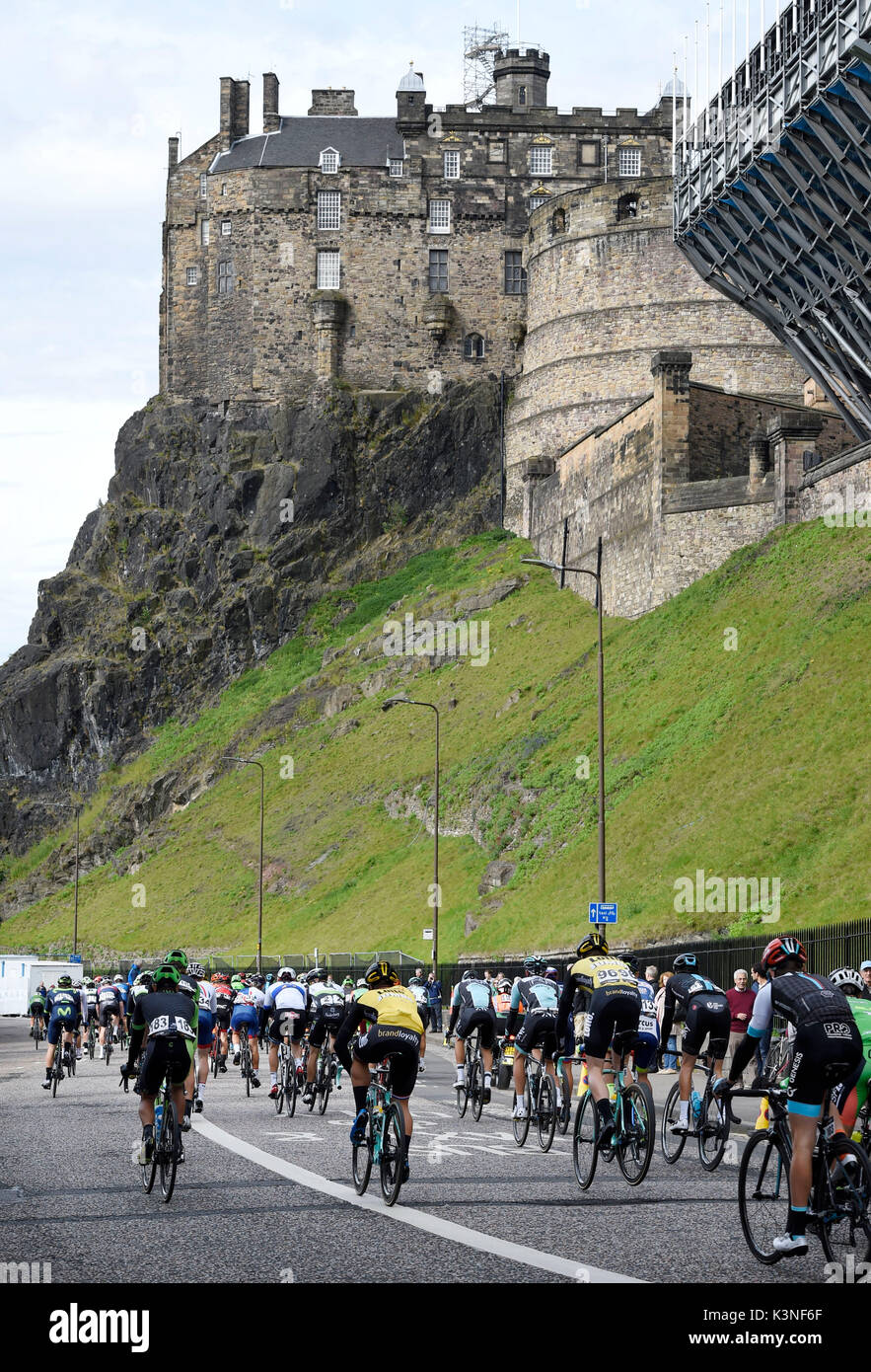 Riders down Johnston Terrace past the castle in Edinburgh City Centre ...