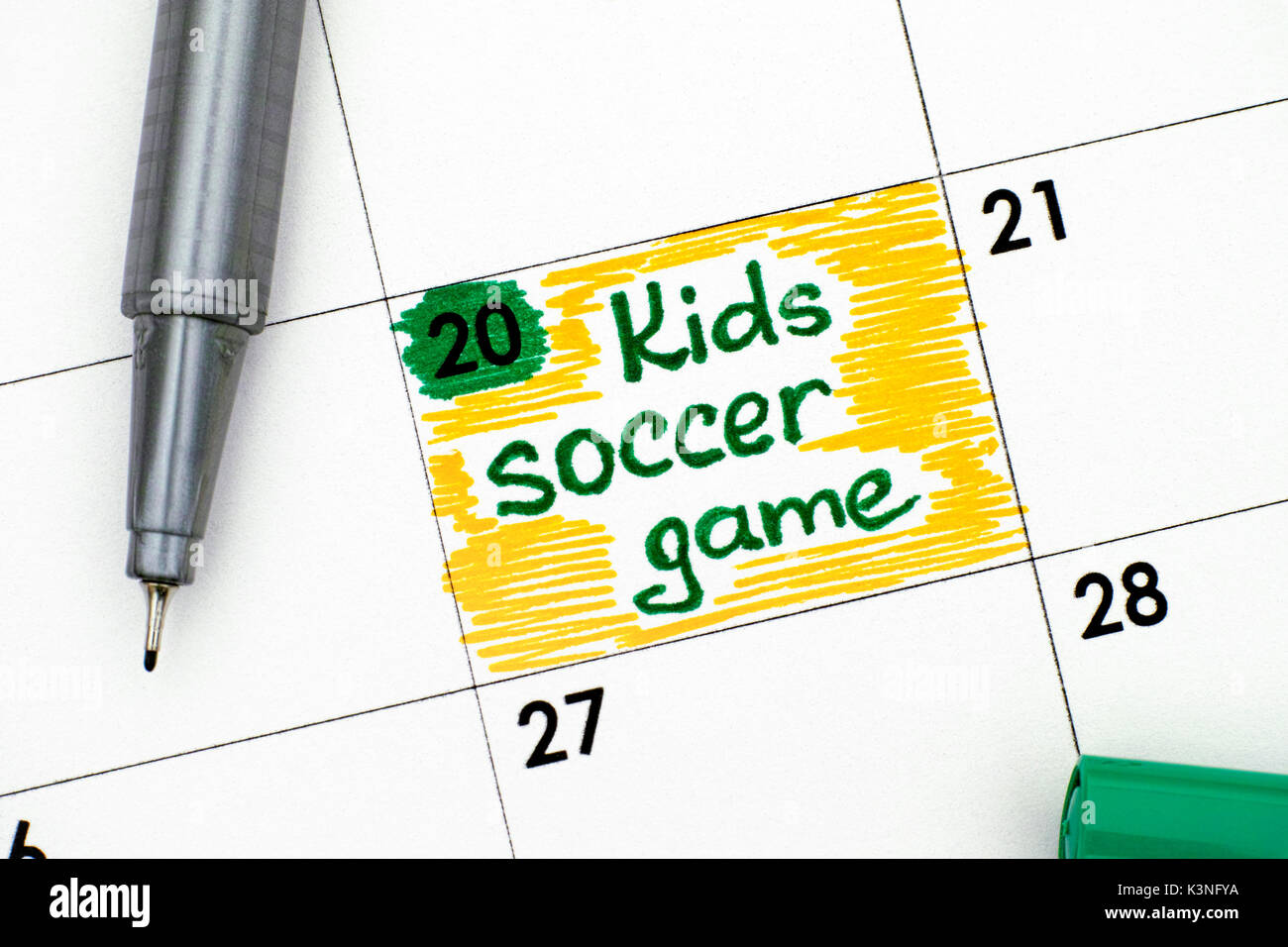 Reminder Kids Soccer Game in calendar with green pen Stock Photo - Alamy