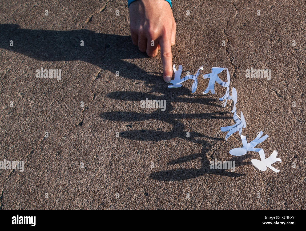 Human figures of cut paper in written words Stock Photo - Alamy