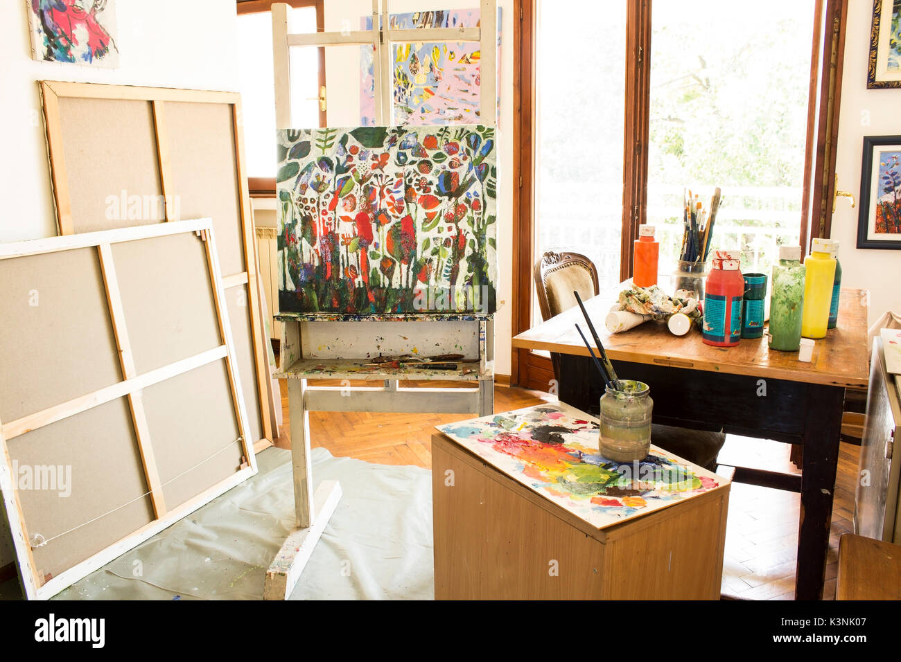 Art studio with paintings and painting equipment Stock Photo - Alamy