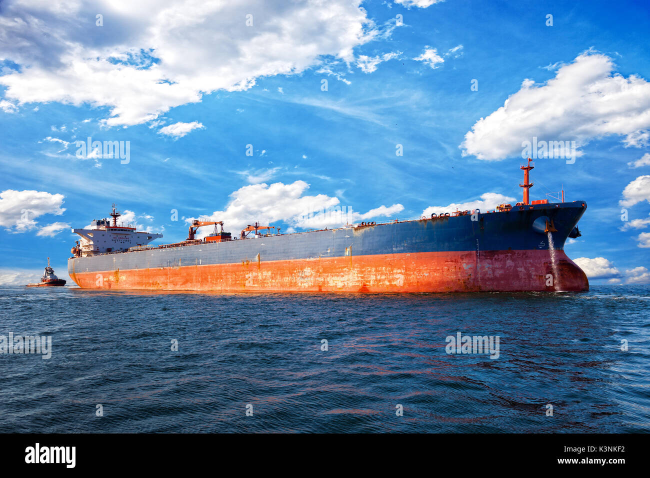 Tug boat towing a tanker ship at sea Stock Photo - Alamy