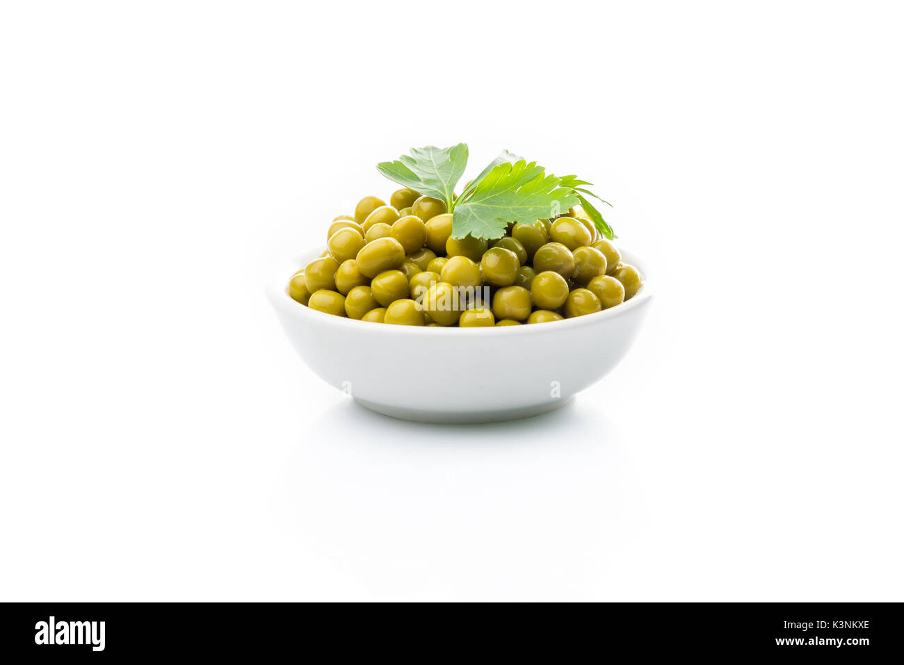 green peas in a bowl isolated, white background Stock Photo - Alamy
