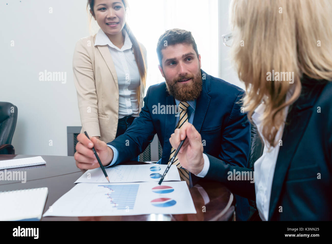 Business analyst smiling while interpreting financial reports sh Stock ...