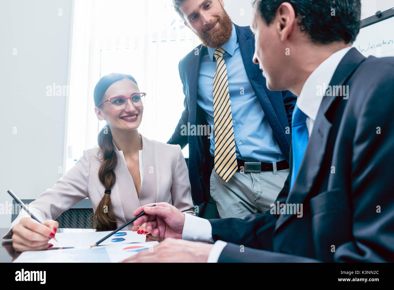 Business analyst smiling while interpreting financial reports sh Stock ...