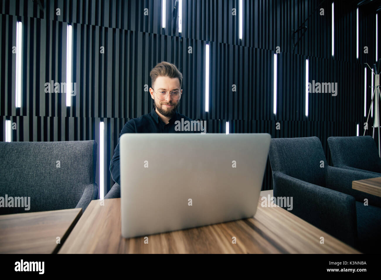 Successful businessman working on laptop in modern luxury office desk ...