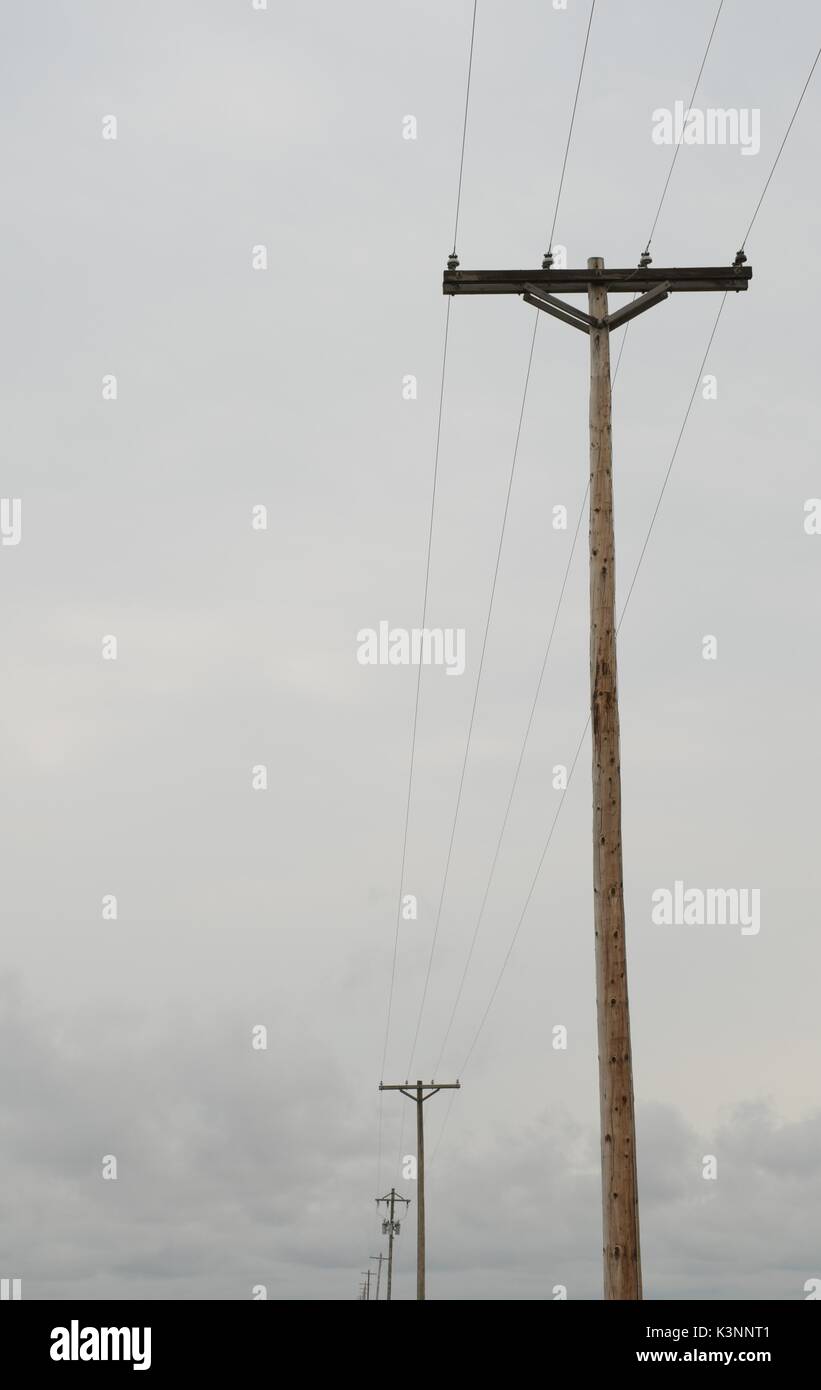 Wooden power utility pole and clear and cloudy blue sky Stock Photo - Alamy