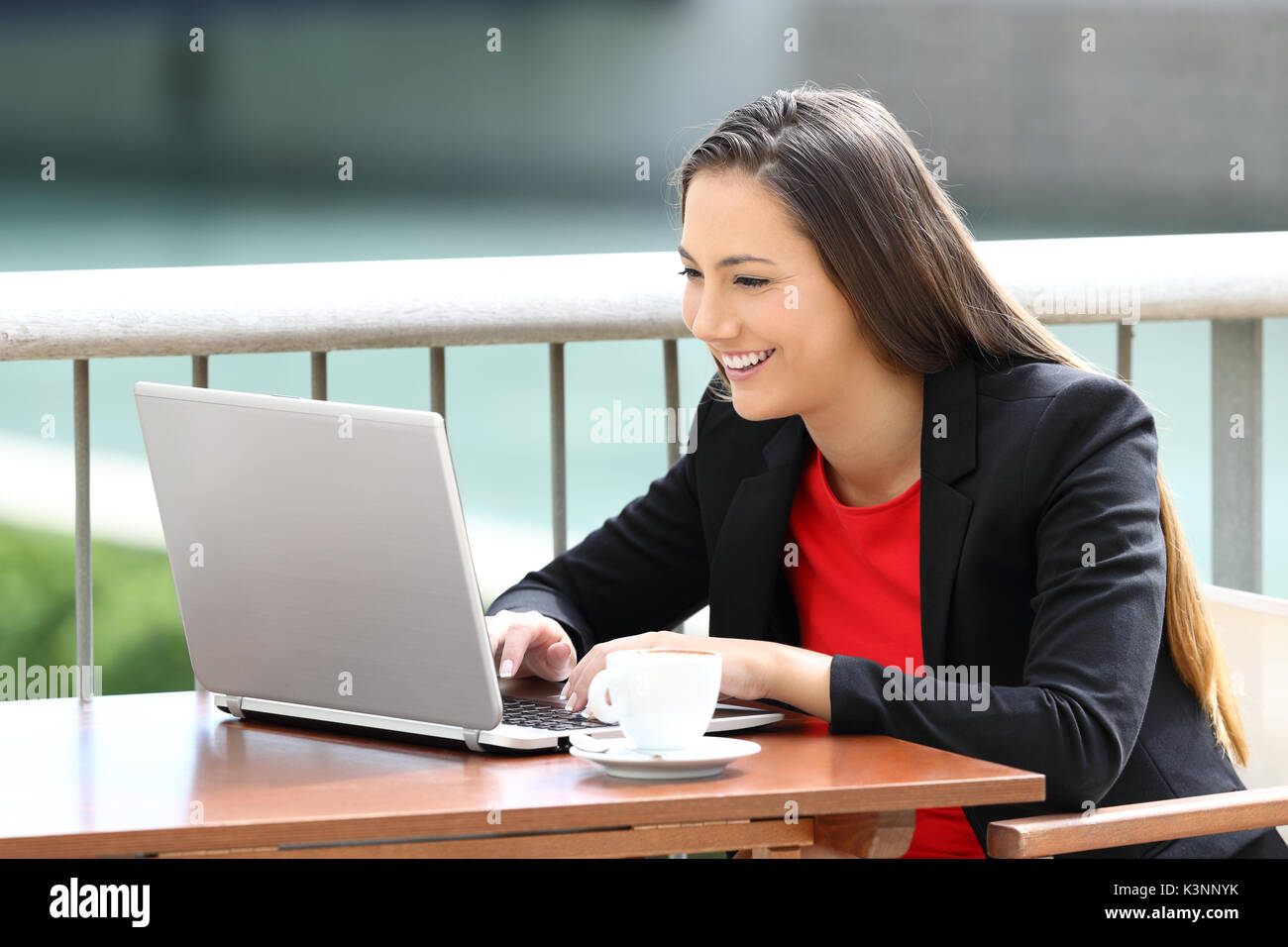Happy single executive woman typing in a laptop sitting in a bar Stock ...
