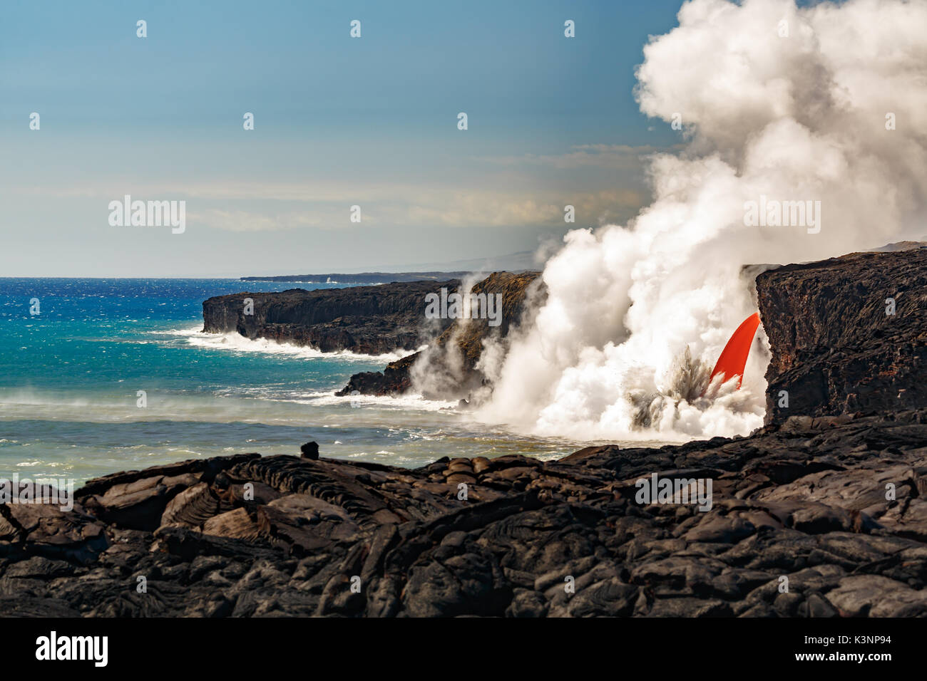 Aerial daytime view of firehose waterfall shaped flow of red lava in ...