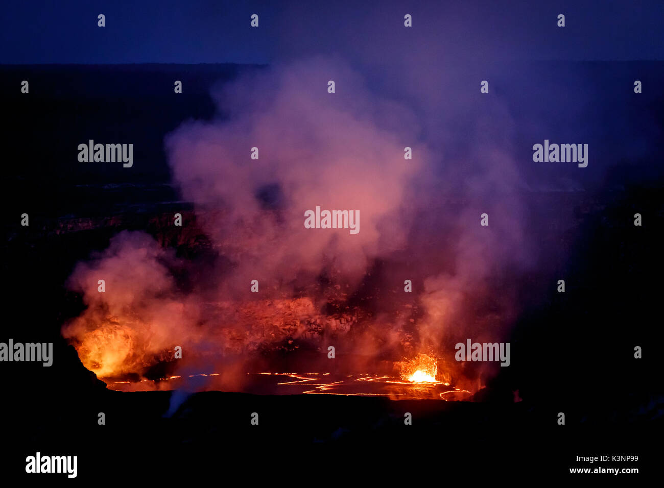 Vibrant colors surround crater of active volcano glowing in the ...