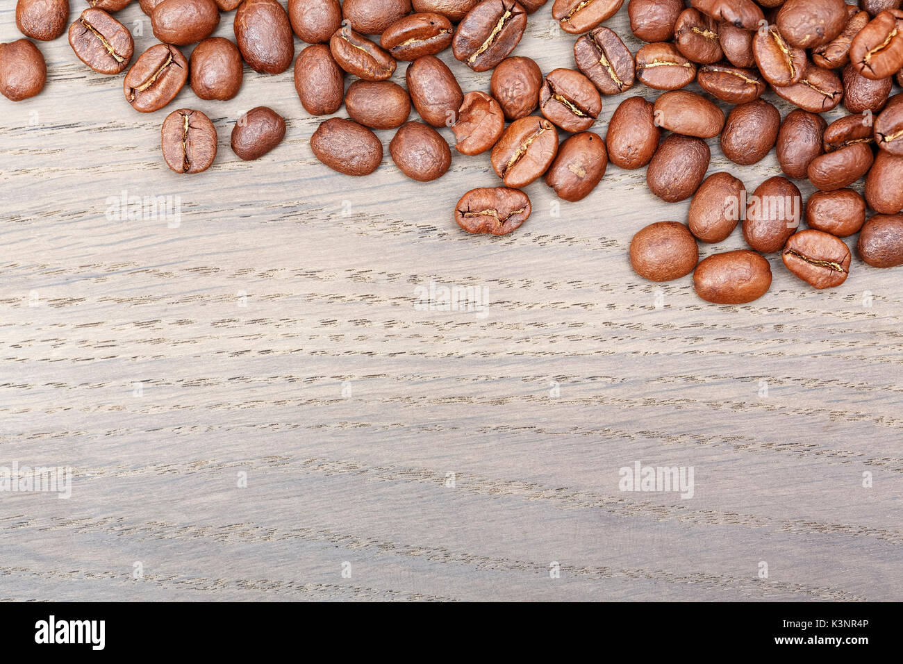 Coffee beans border on old oak table Stock Photo - Alamy