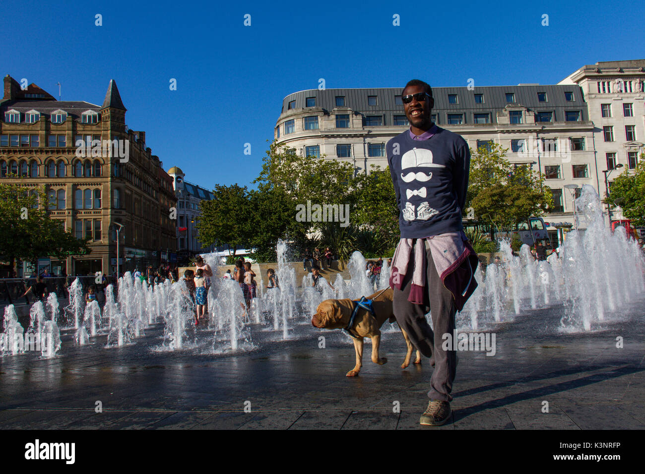 Manchester, United Kingdom - 15 August, 2017: Man and his dog walk by ...