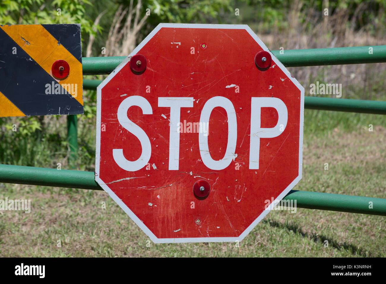 Stop sign on a gate indicating a blocked road Stock Photo - Alamy