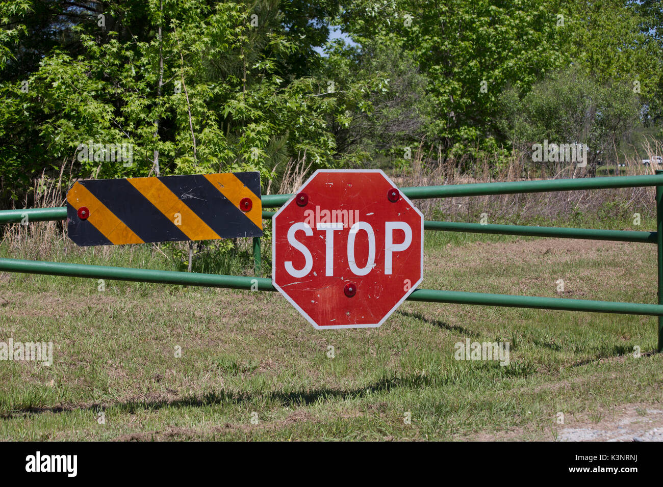 Stop sign on a gate indicating a blocked road Stock Photo - Alamy