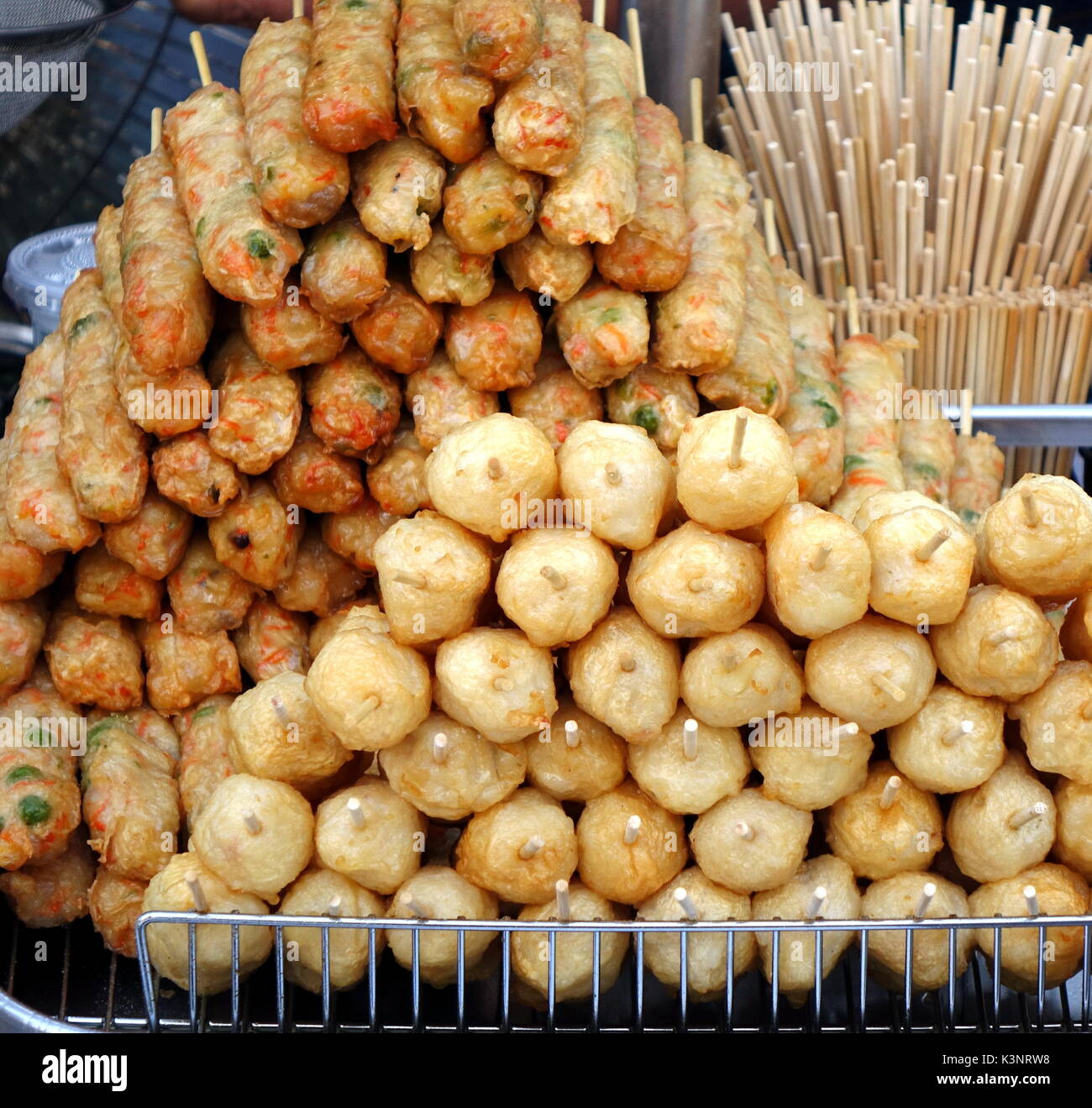 An outdoor vendor sells fried fish balls and fish sausages Stock Photo ...