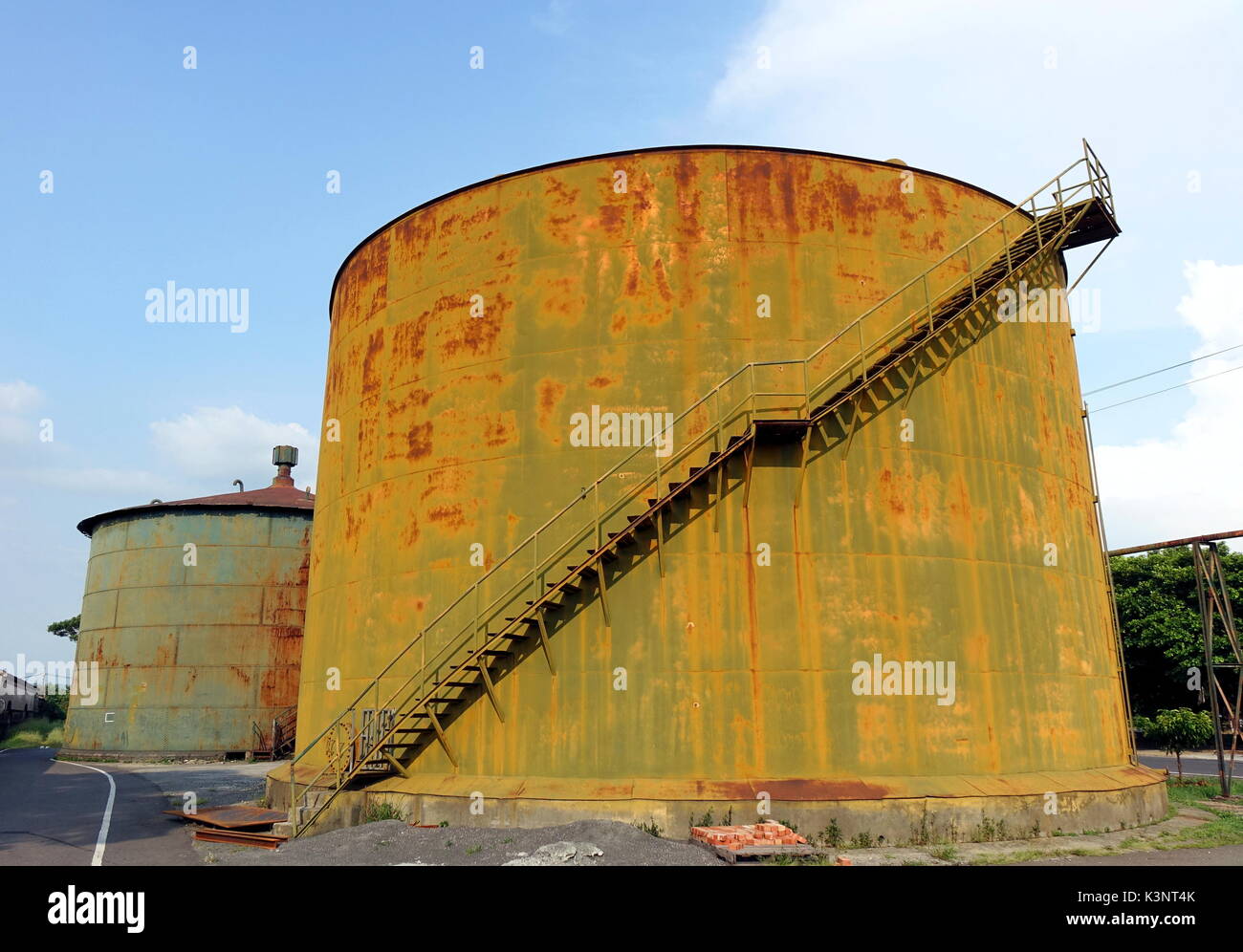 Two large rusting storage tanks at a vintage industrial facility Stock ...