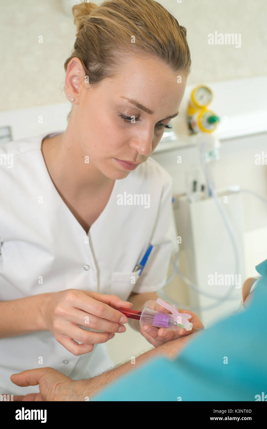 taking blood sample from patient at the doctors office thailand Stock ...