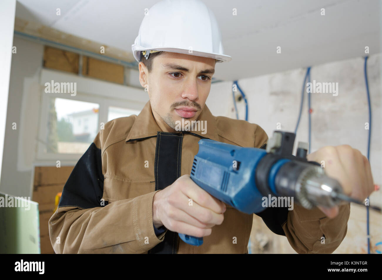 builder worker with r drill perforator equipment Stock Photo - Alamy