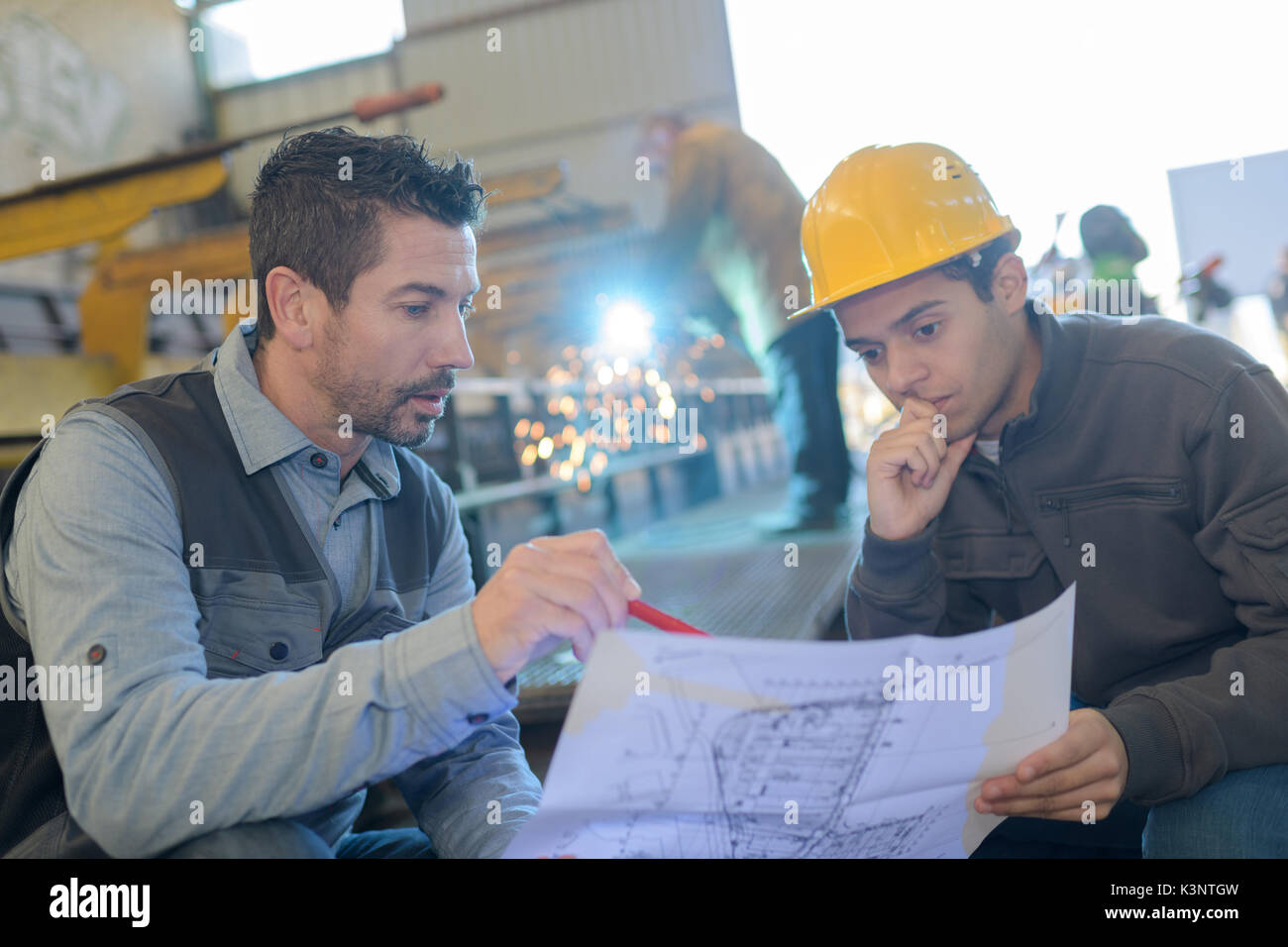 Industrial engineer showing plan hi-res stock photography and images ...