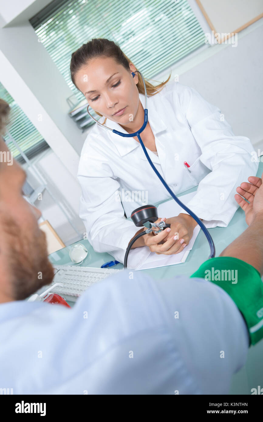 Carer checking blood pressure hi-res stock photography and images - Alamy