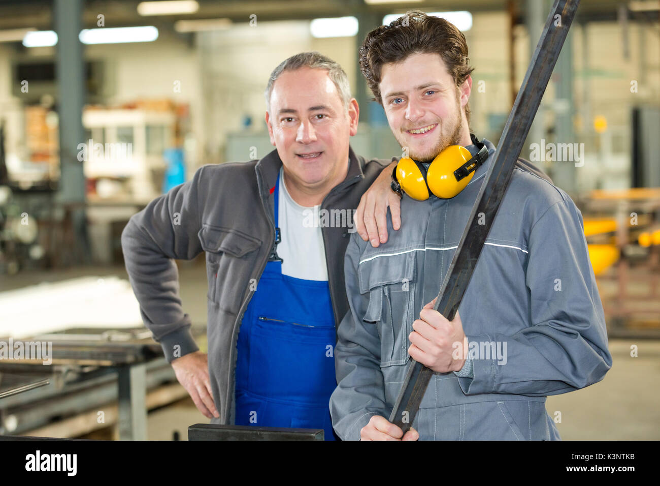 factory trainer and teacher posing Stock Photo - Alamy