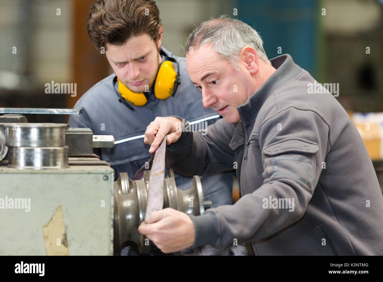 young machinist observing the teacher Stock Photo - Alamy