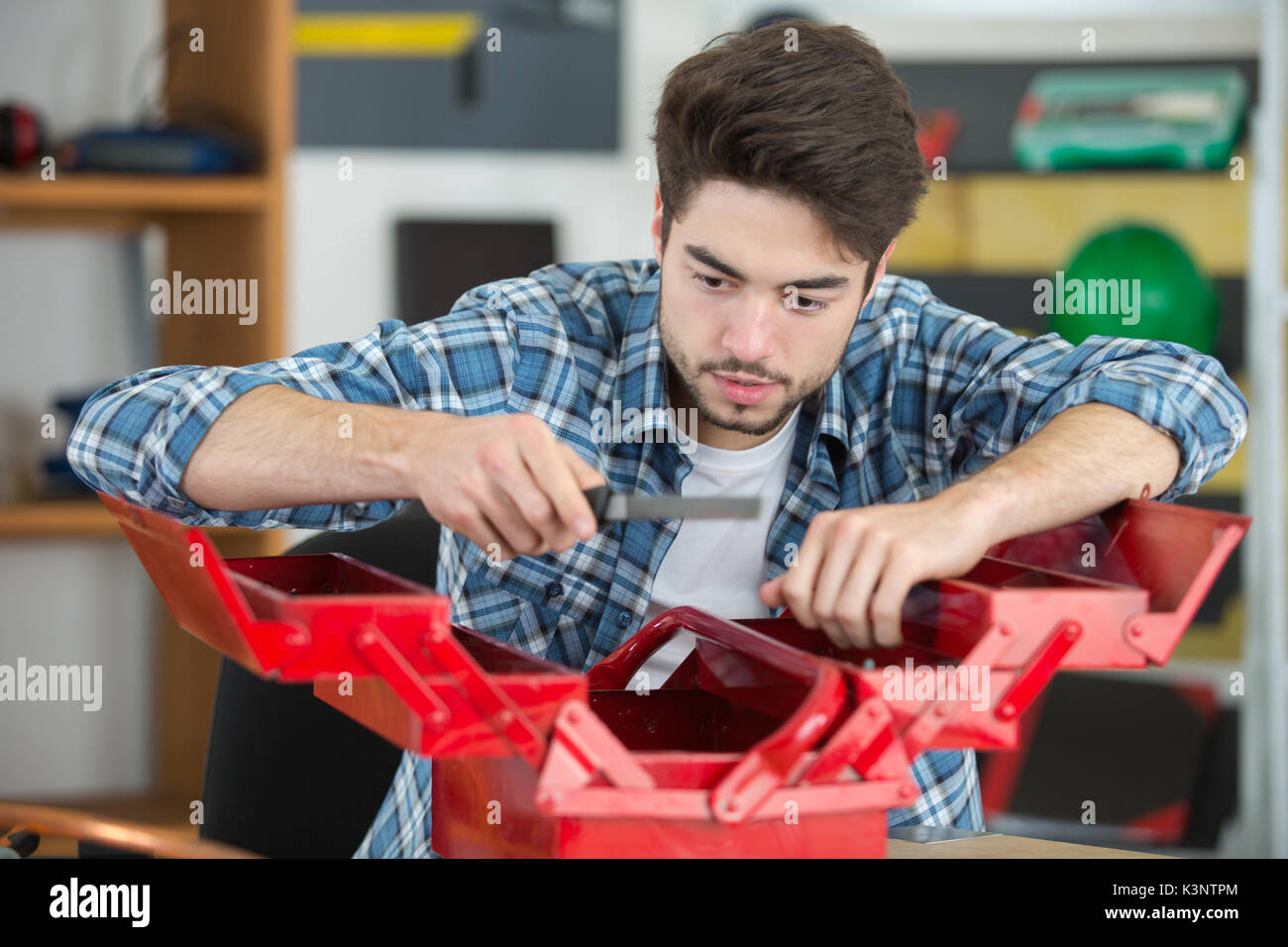 man looking in his tool box Stock Photo - Alamy