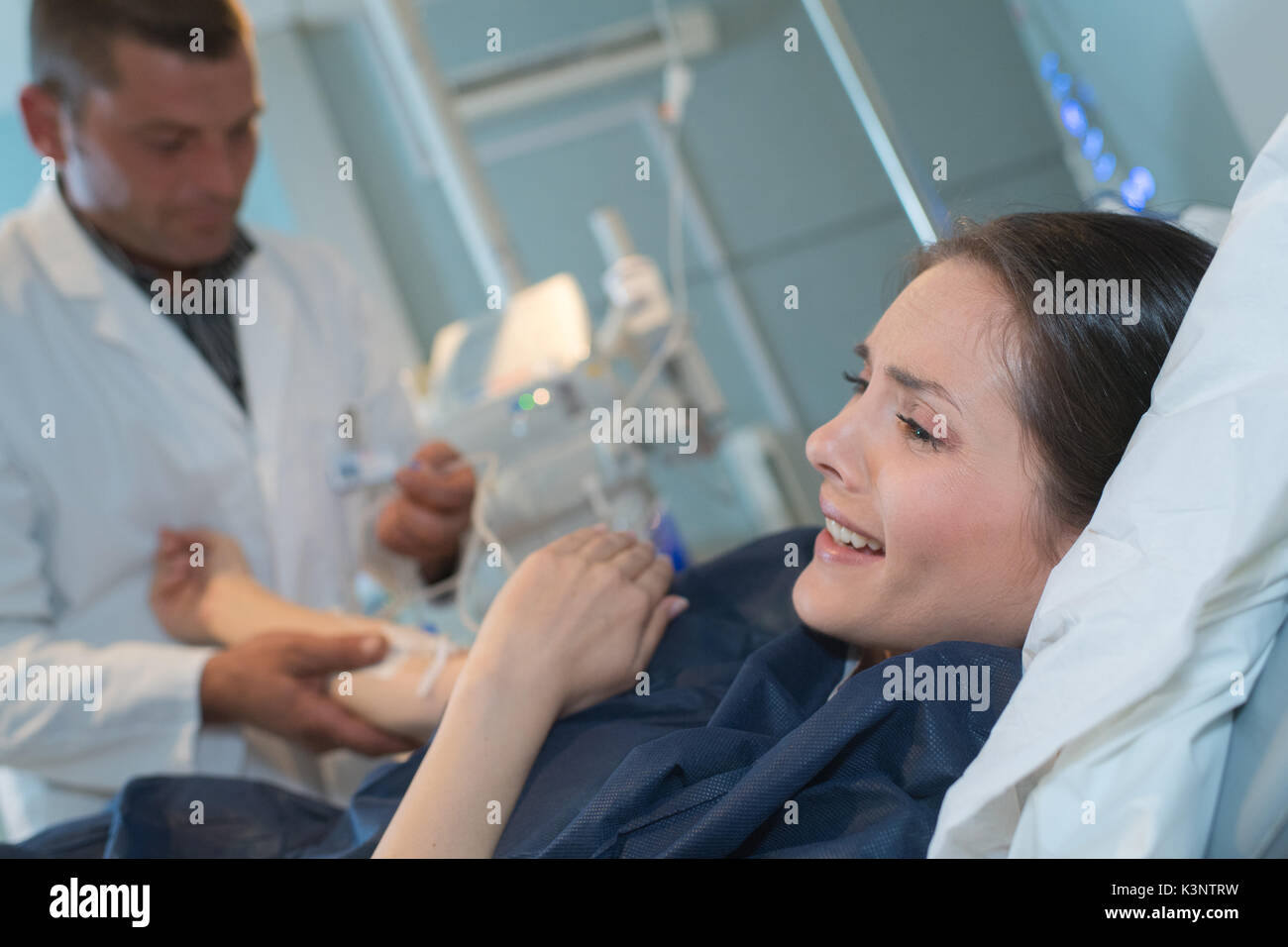 patient screaming while doctor drawing blood sample in hospital room ...