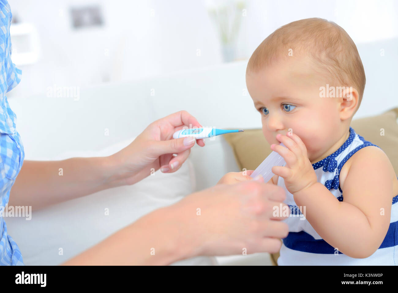 woman taking babys temperature Stock Photo - Alamy