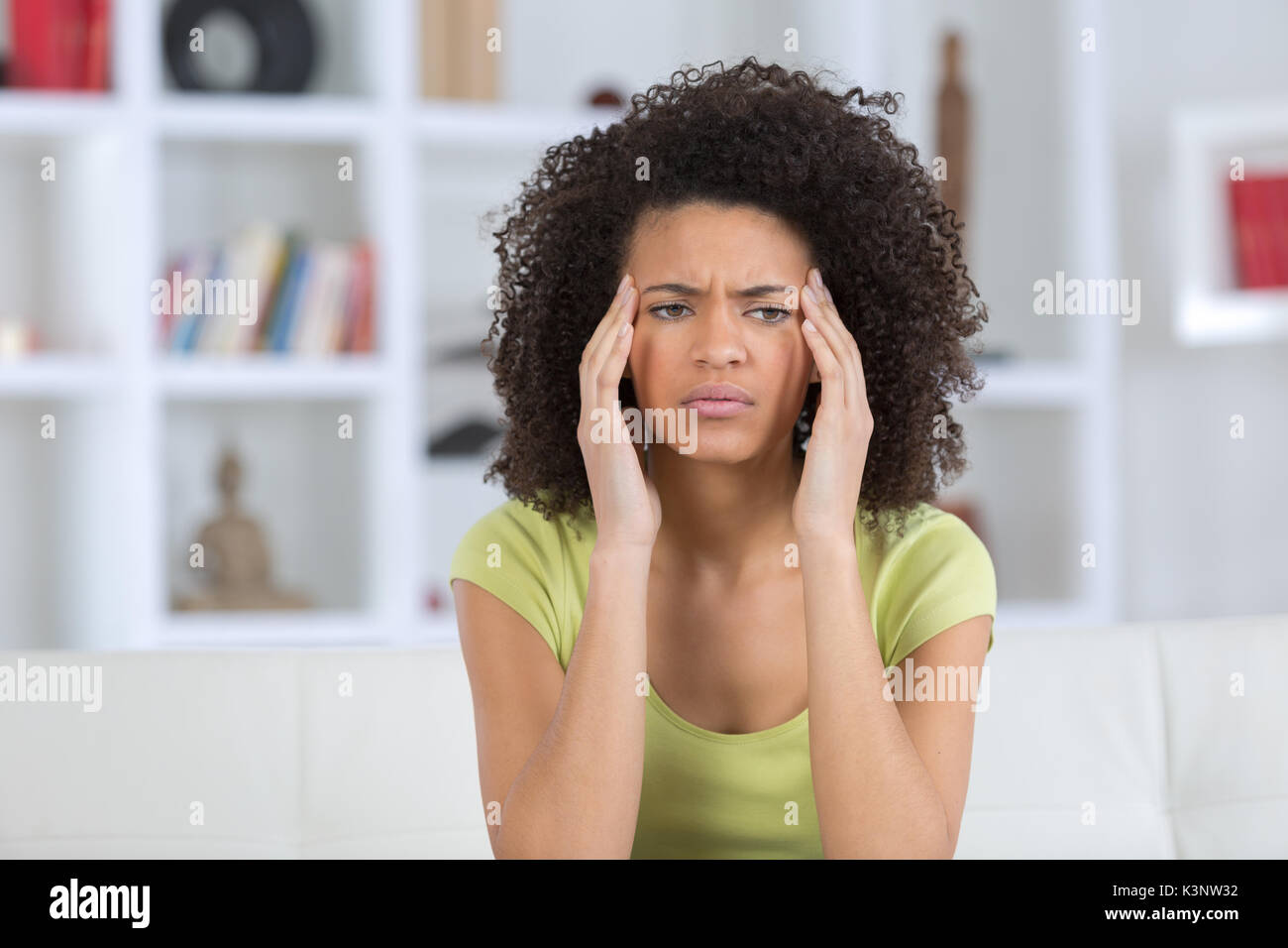 young woman feeling headacke with hands on her head Stock Photo - Alamy