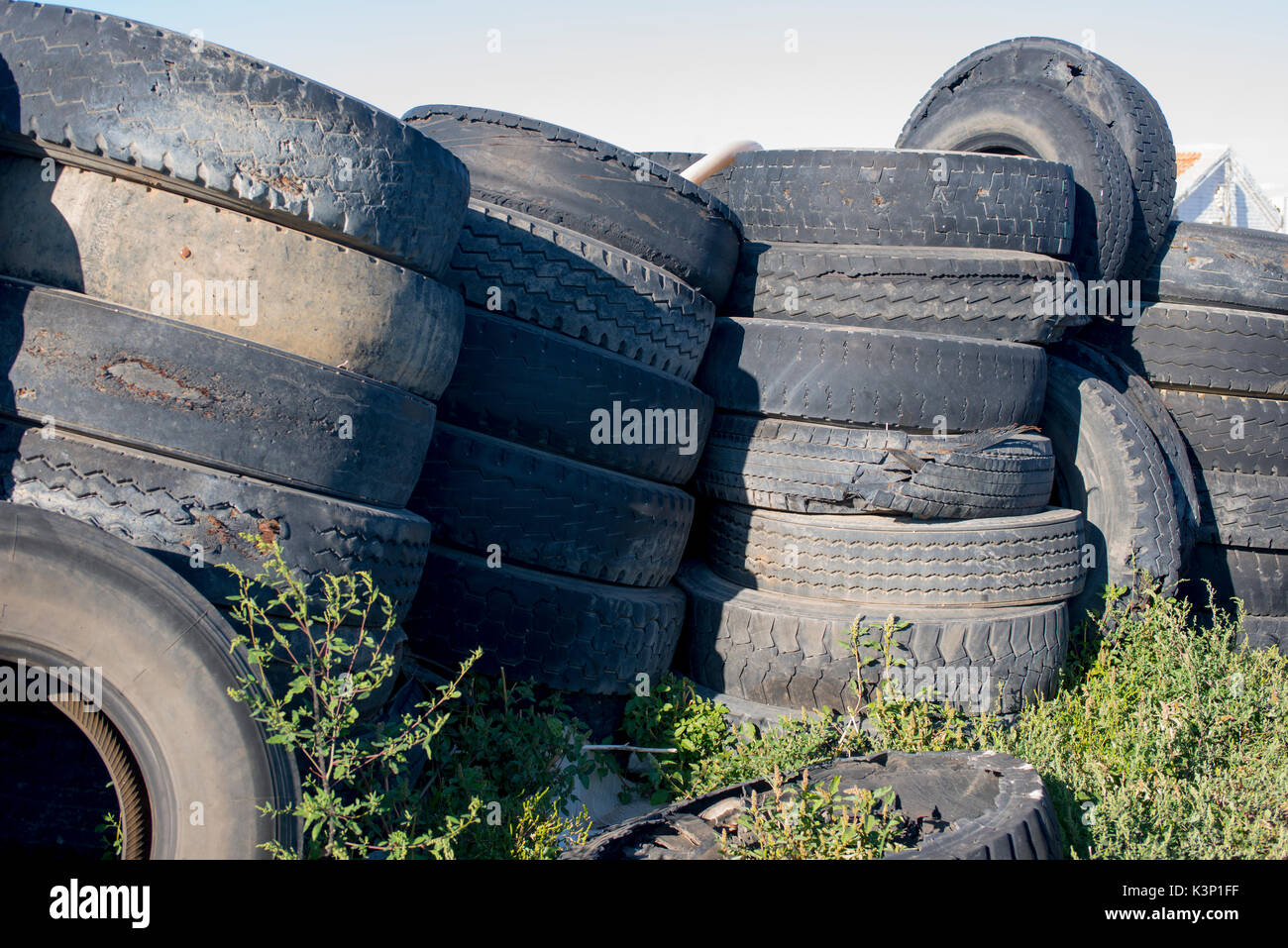 Black tyres abandoned on the ground, a sign of pollution Stock Photo ...