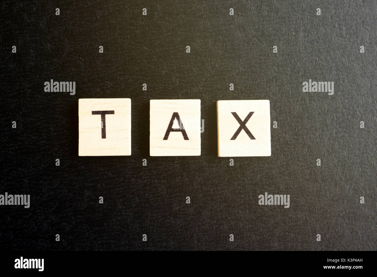 Tax word on wood blocks with black background with filter and analog ...