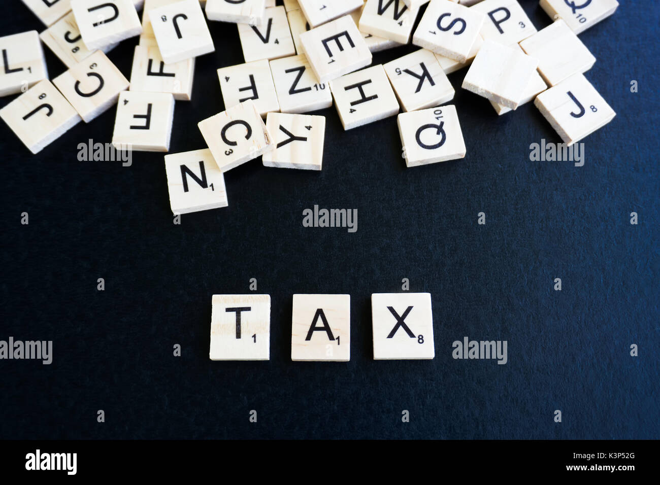 Tax word on wood blocks with black background with filter and analog ...