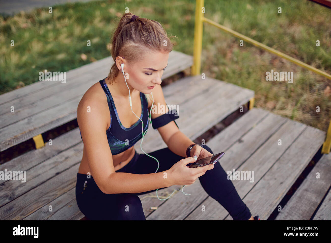 Girl runner happy after jogging raised her hands up Stock Photo - Alamy