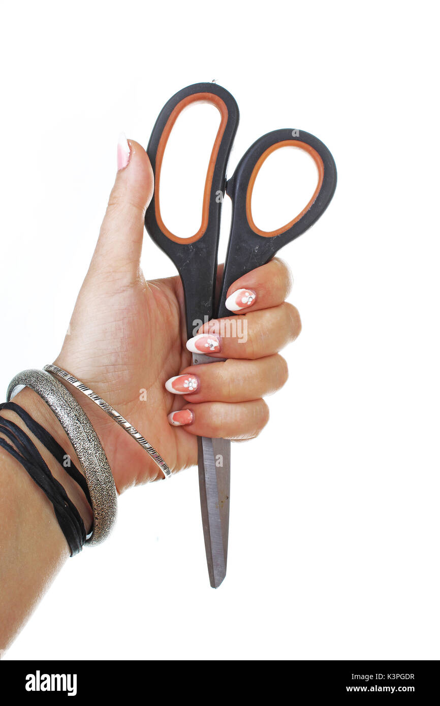 Woman hand holding scissors on isolated white cutout background. Studio ...