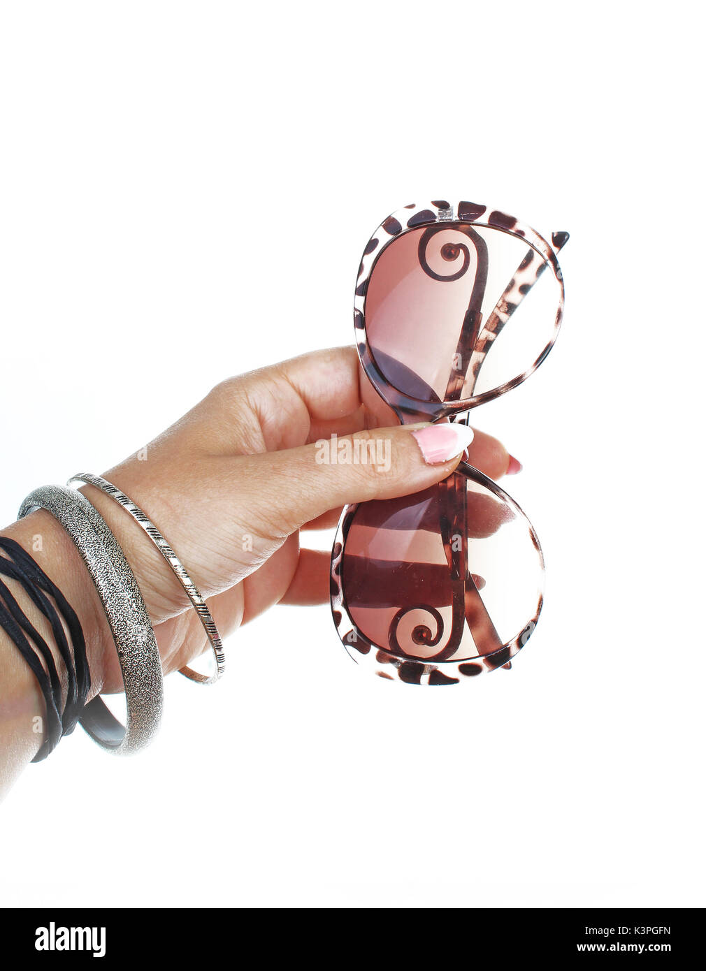 Woman hand holding sunglasses on isolated white cutout background ...