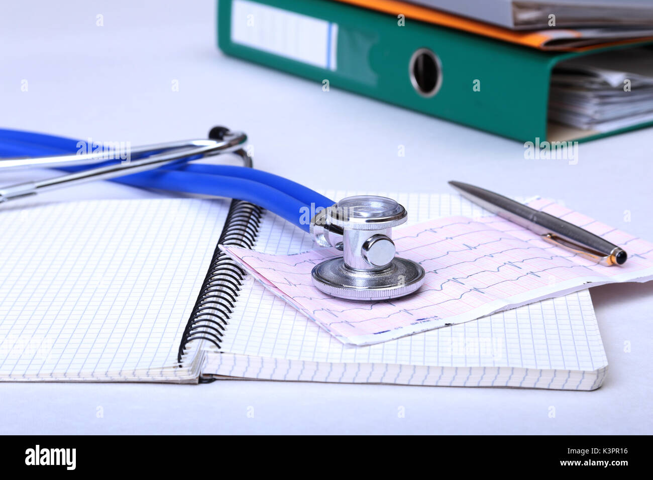 Folder file, stethoscope and RX prescription on the desk. blurred ...