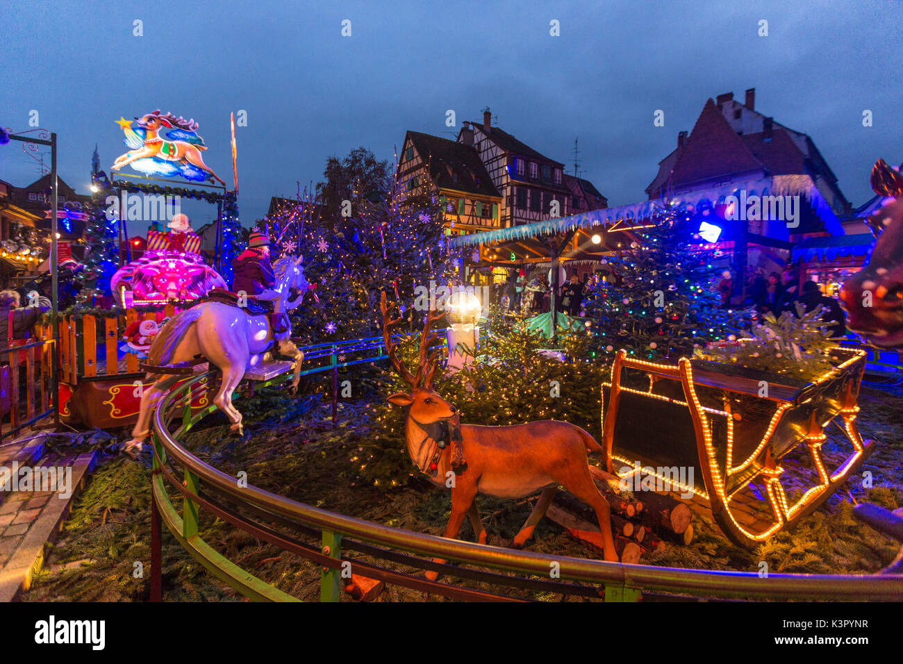 Christmas lights and typical carousel in the old medieval town Colmar ...