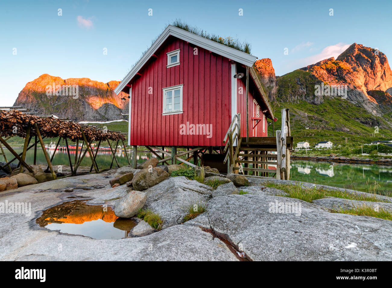 Typical house of fishermen called Rorbu lighted up by midnight sun ...