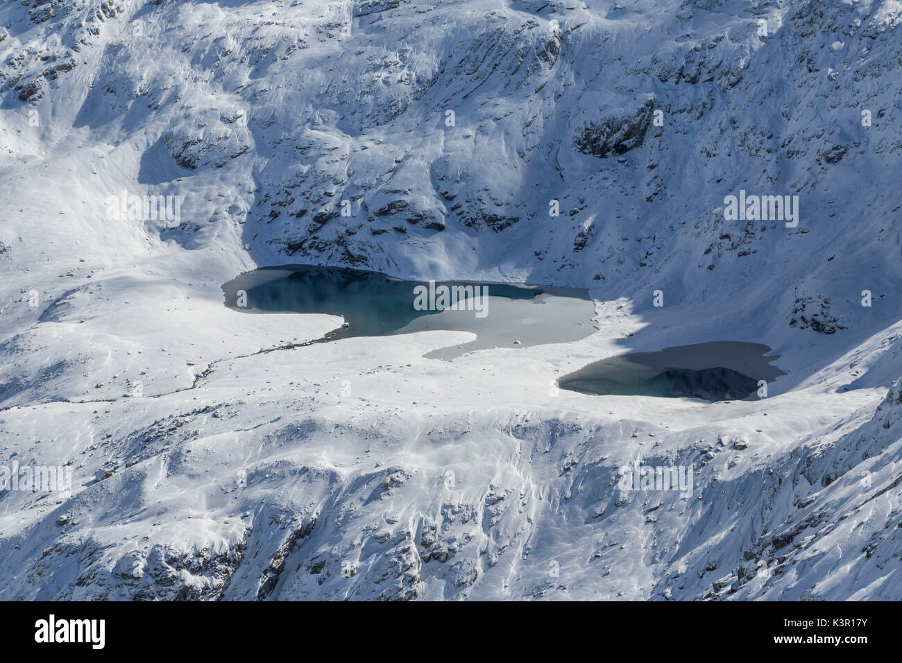 Aerial view of Lakes of Stella framed by snowy peaks Val di Lei ...