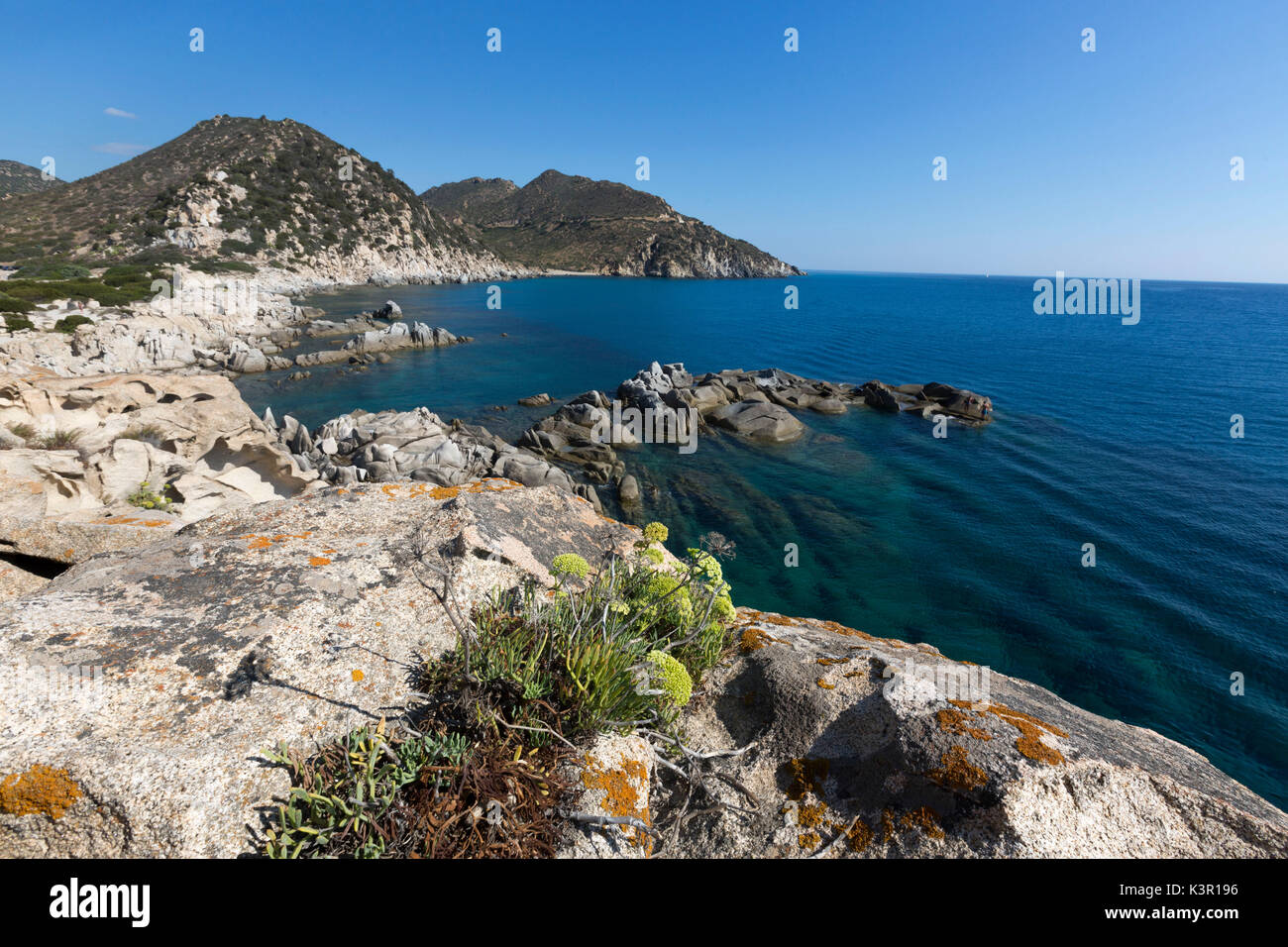 View of cliffs and headlands surrounding the blue sea Punta Molentis ...