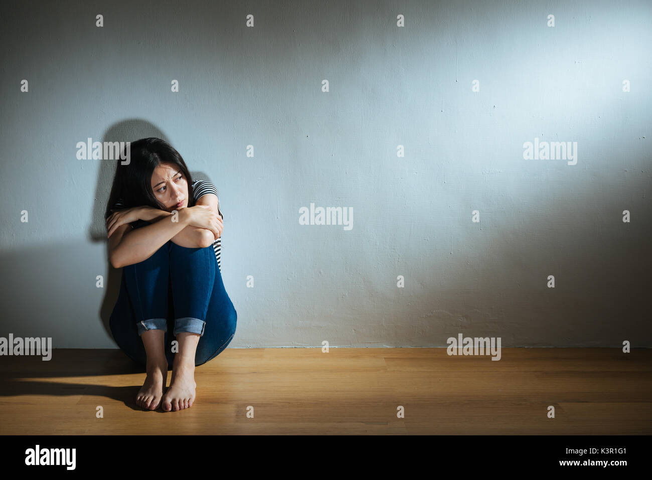 sadness despair girl looking at light feeling afraid sitting on wooden ...