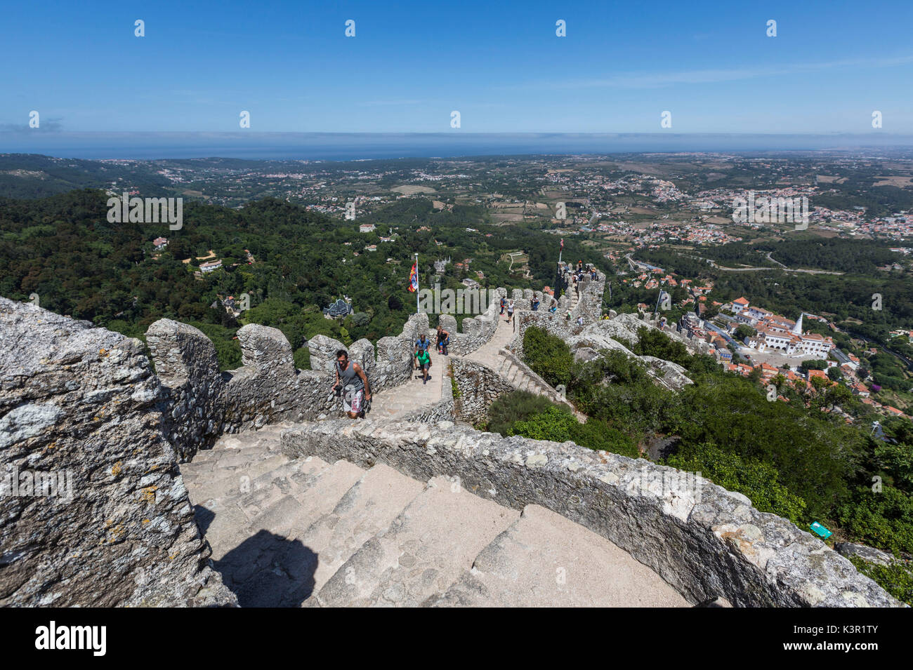 Tourists proceed on fortified stone path of the ancient Castelo dos ...